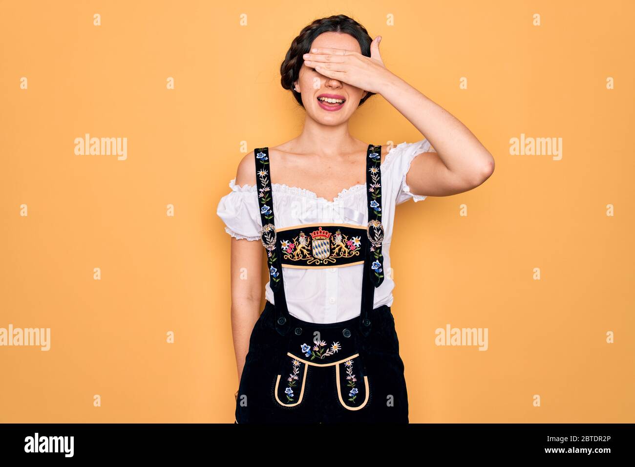 Young beautiful german woman with blue eyes wearing traditional ...