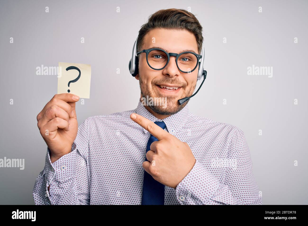 Young call center operator business man with blue eyes holding paper ...