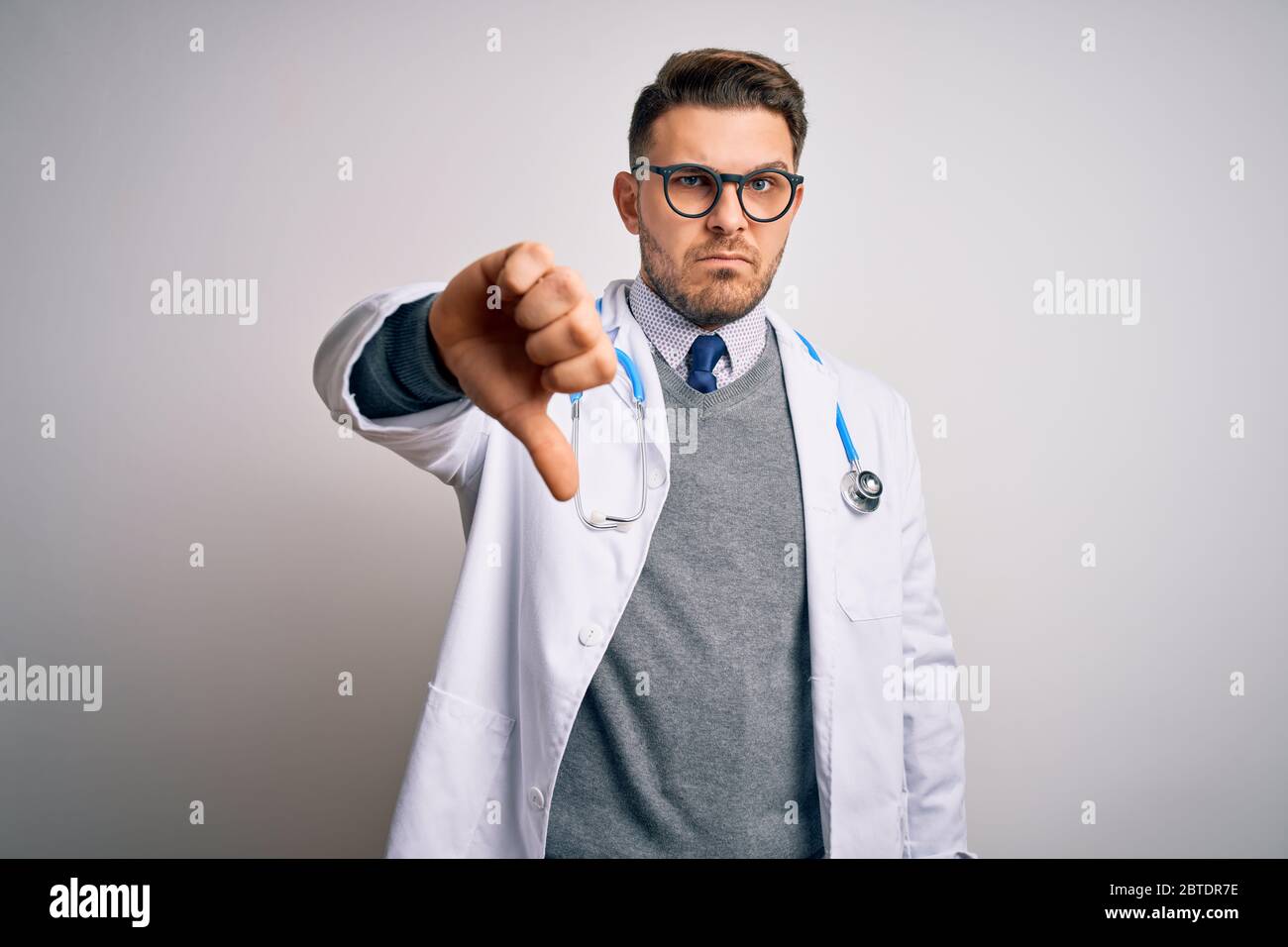 Young doctor man with blue eyes wearing medical coat and stethoscope ...