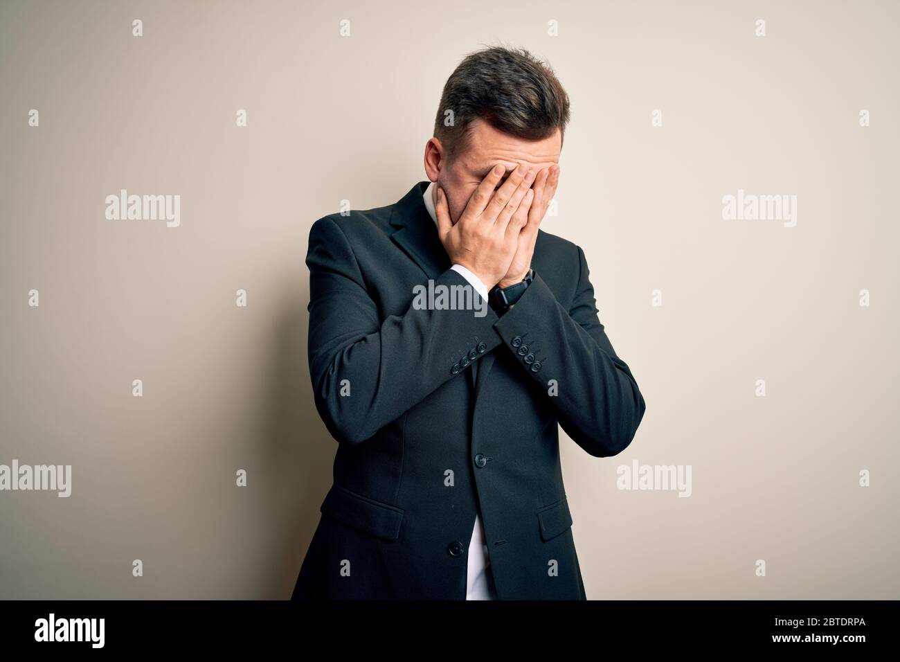 Young handsome business man wearing elegant suit and tie over isolated ...
