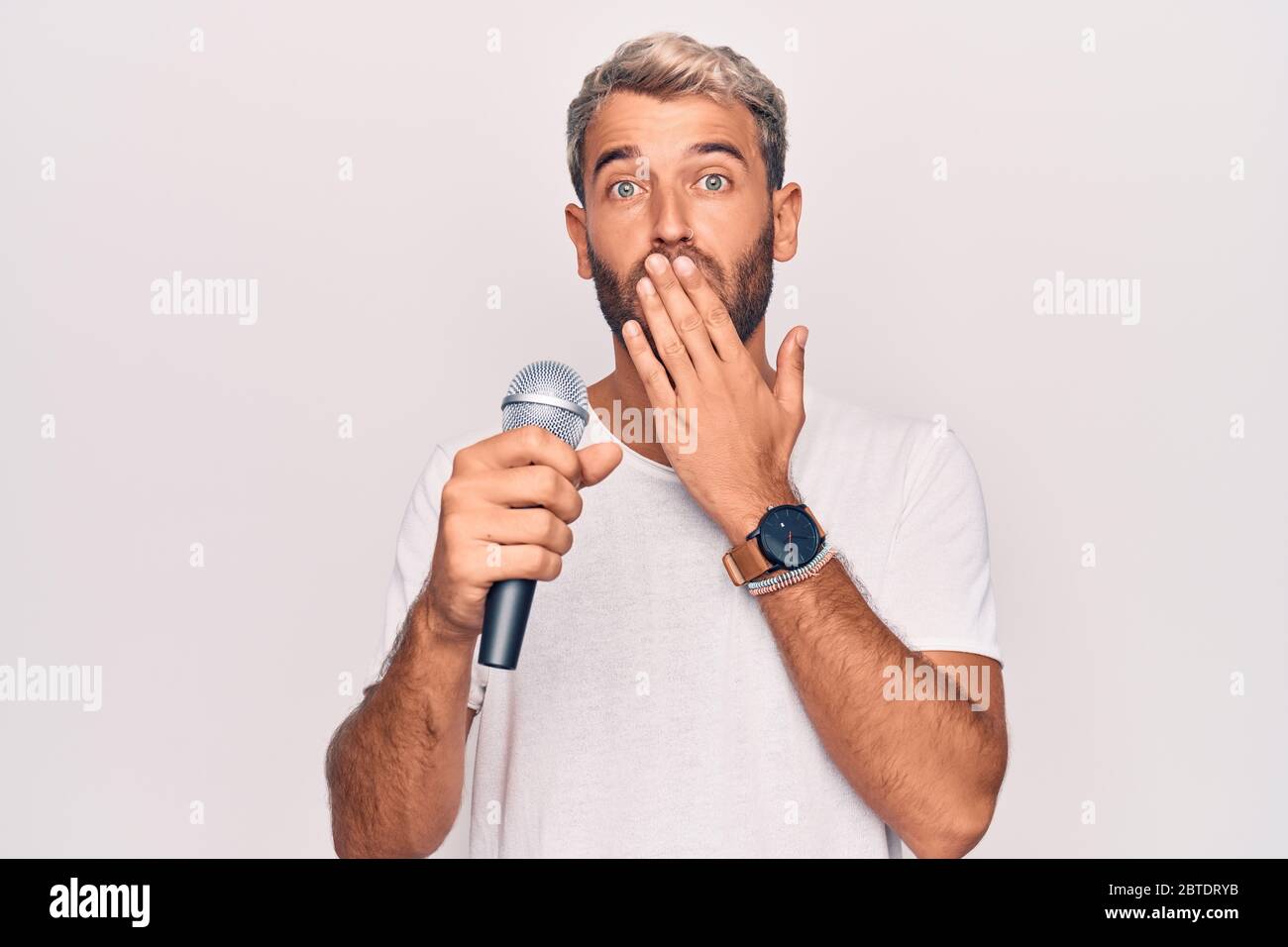 Handsome blond singer man with beard singing song using microphone over ...