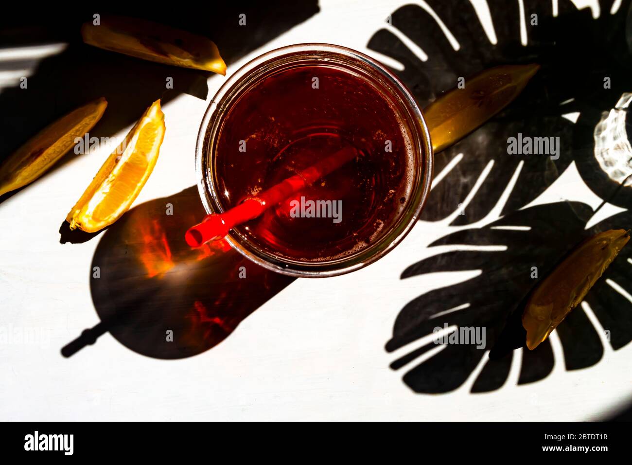 Top view on a glass of lemonade with red tube, slices of lemons and a ...