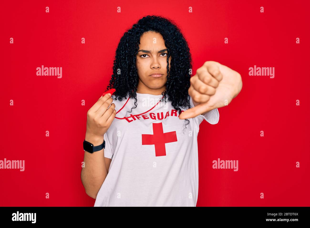 Young african american curly lifeguard woman wearing t-shirt with red ...
