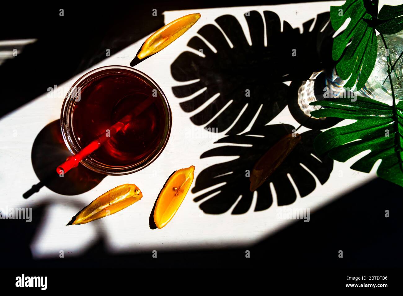 Top view on a glass of lemonade with red tube, slices of lemons and a ...