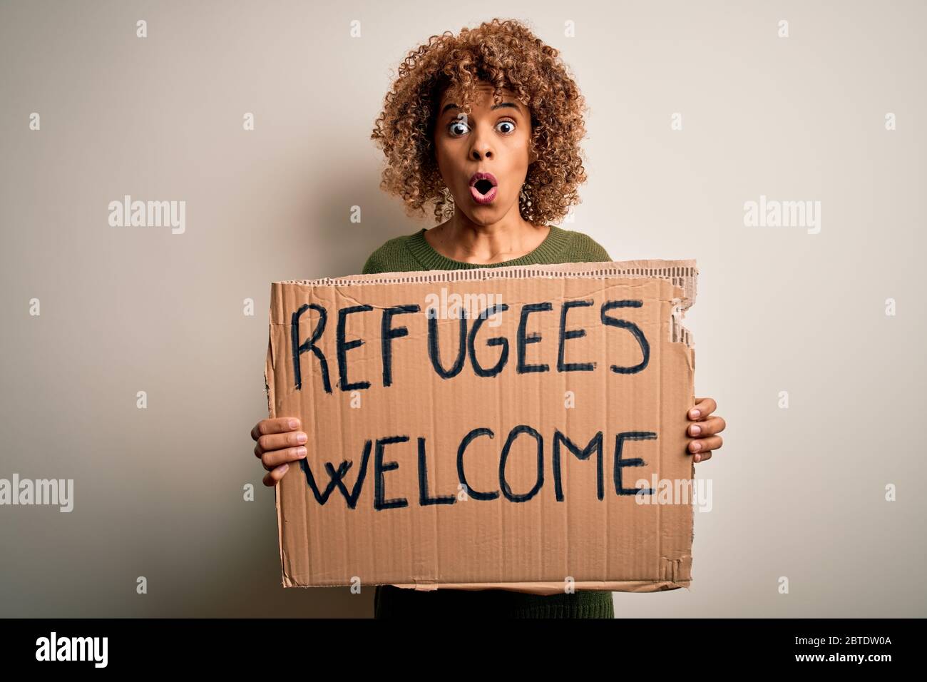 African american woman asking for immigration holding banner with ...