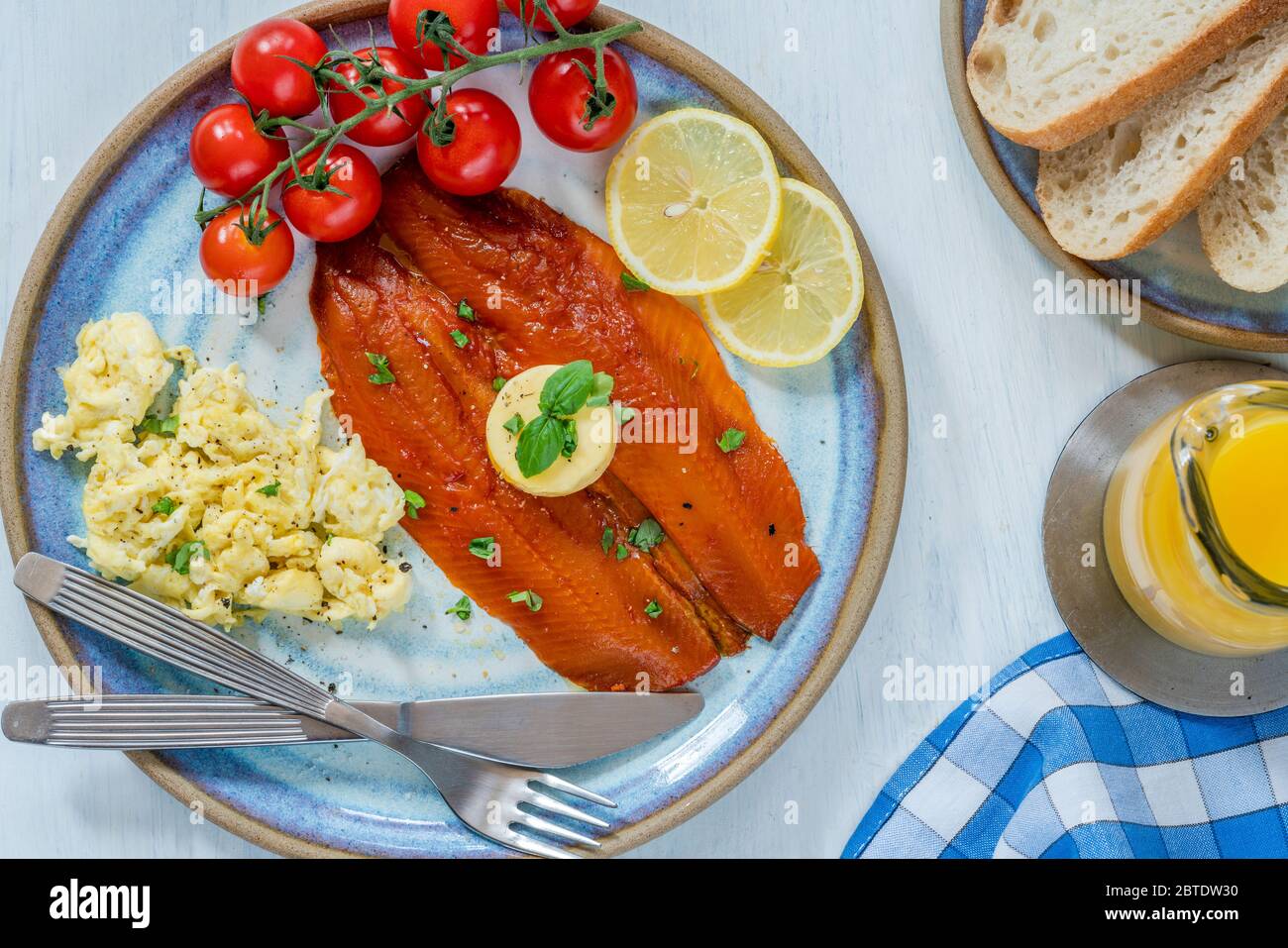 Smoked kipper brunch with scrambled egg and tomatoes - overhead view ...