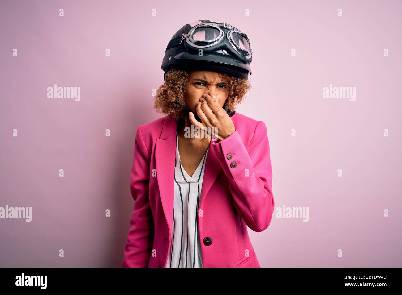 African american motorcyclist woman with curly hair wearing moto helmet ...