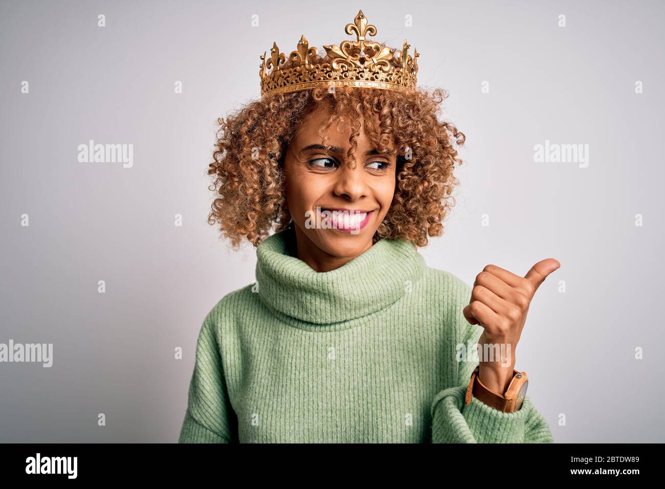 Young african american woman wearing golden crown of queen over ...