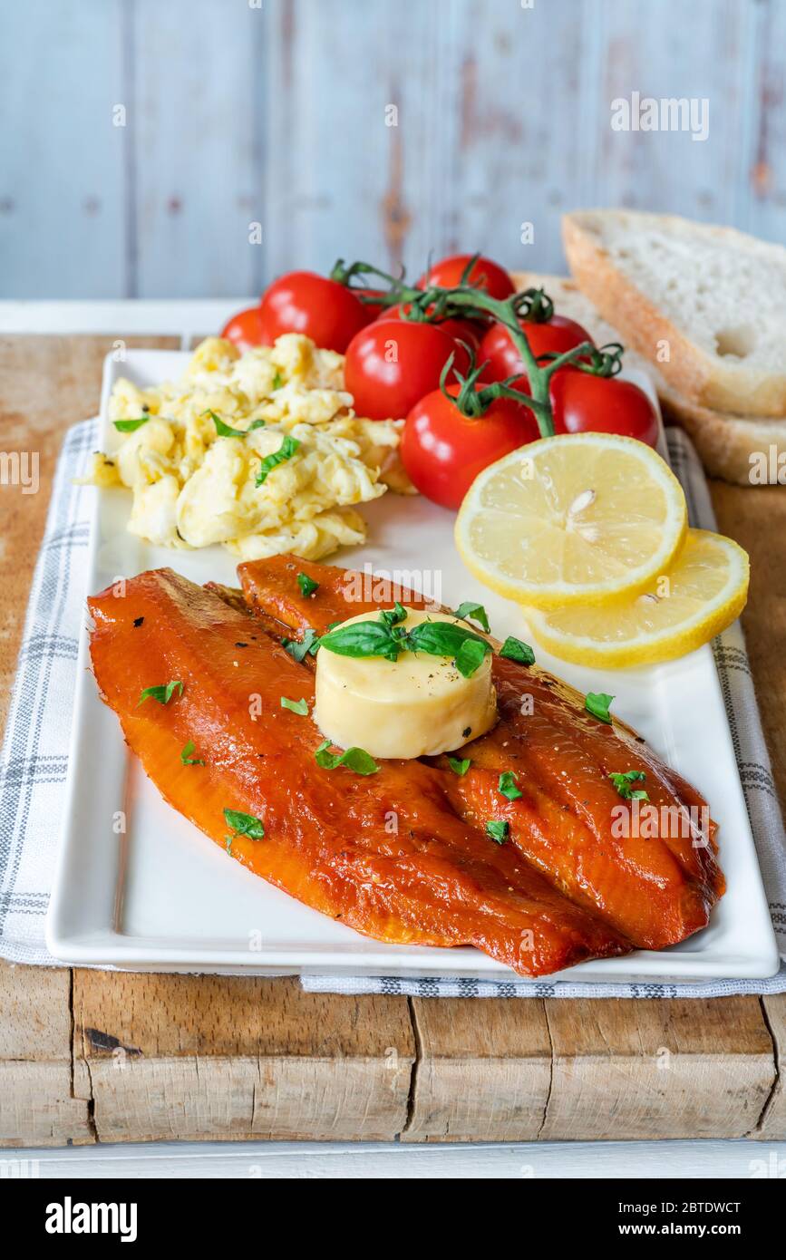 Smoked kipper brunch with scrambled egg and tomatoes Stock Photo - Alamy