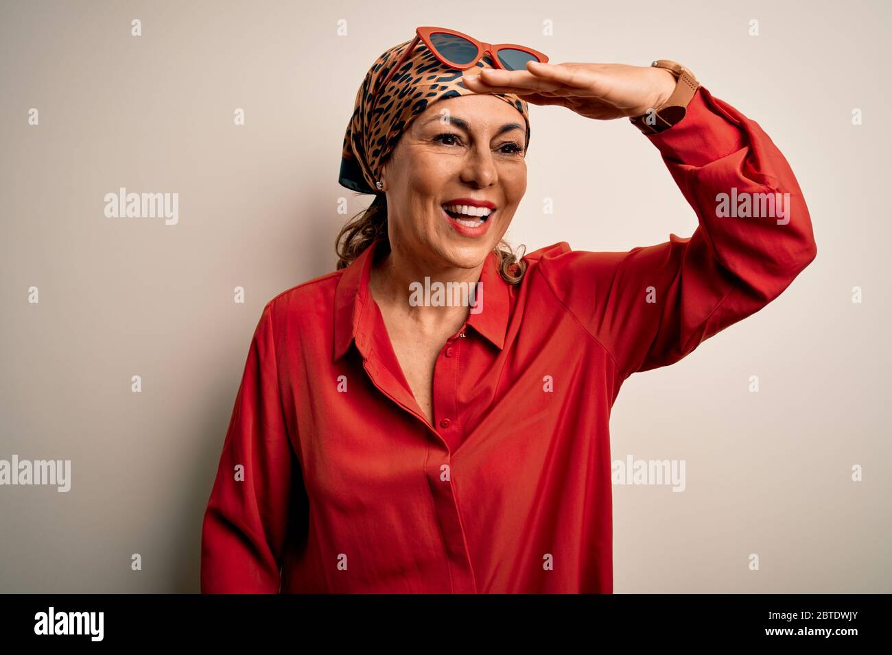 Middle age brunette woman wearing handkerchief on head and shirt over ...