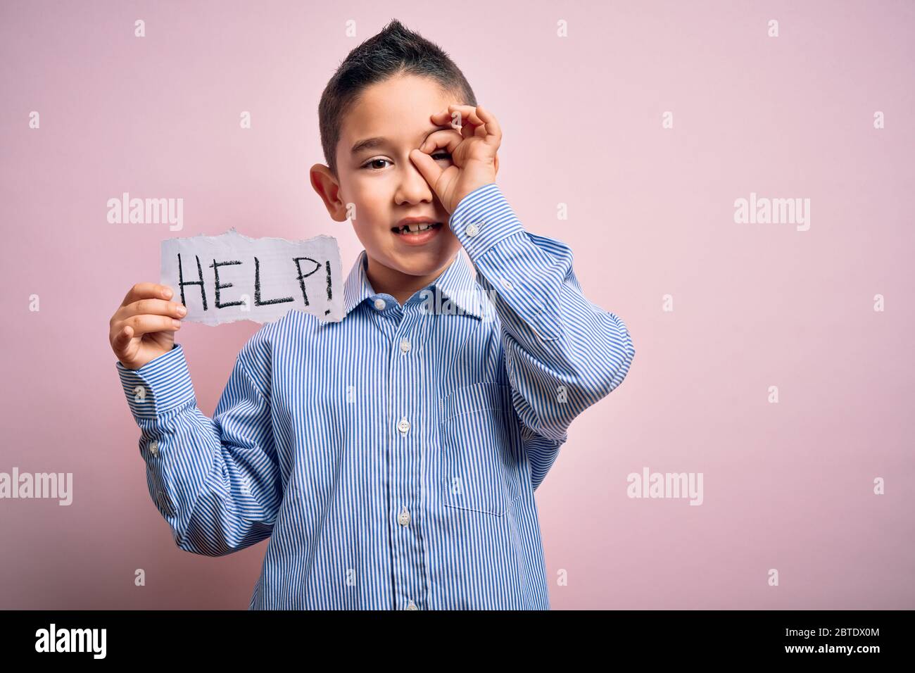 Young little boy kid holding paper sing with help message asking for ...