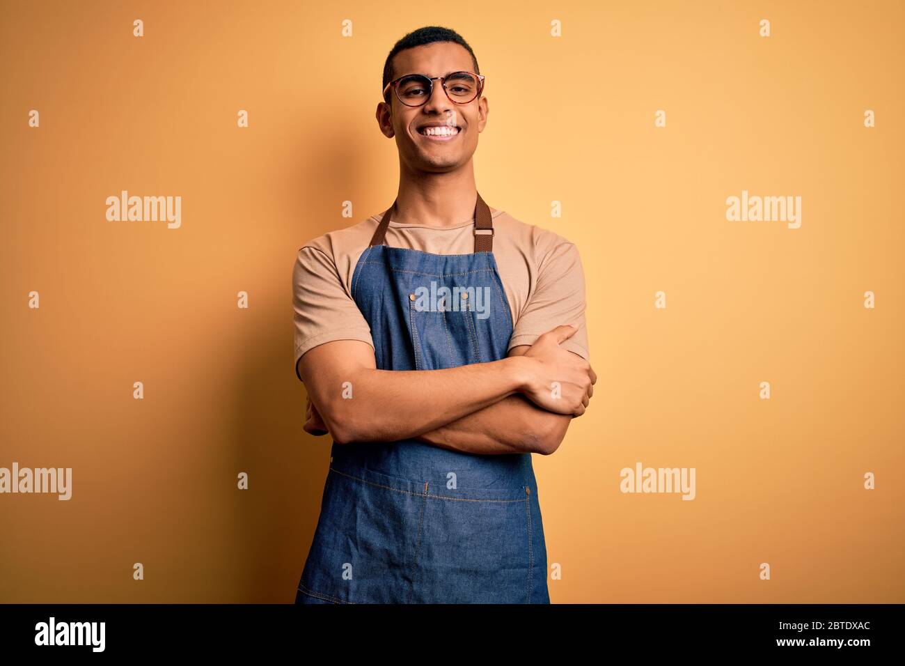 Young handsome african american shopkeeper man wearing apron over ...