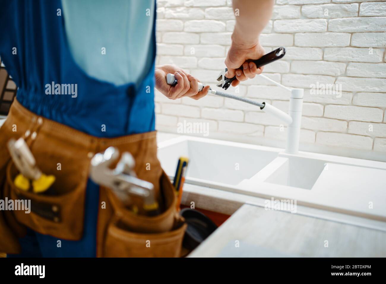 Handyman plumber fixing plumbing kitchen sink hi-res stock photography ...