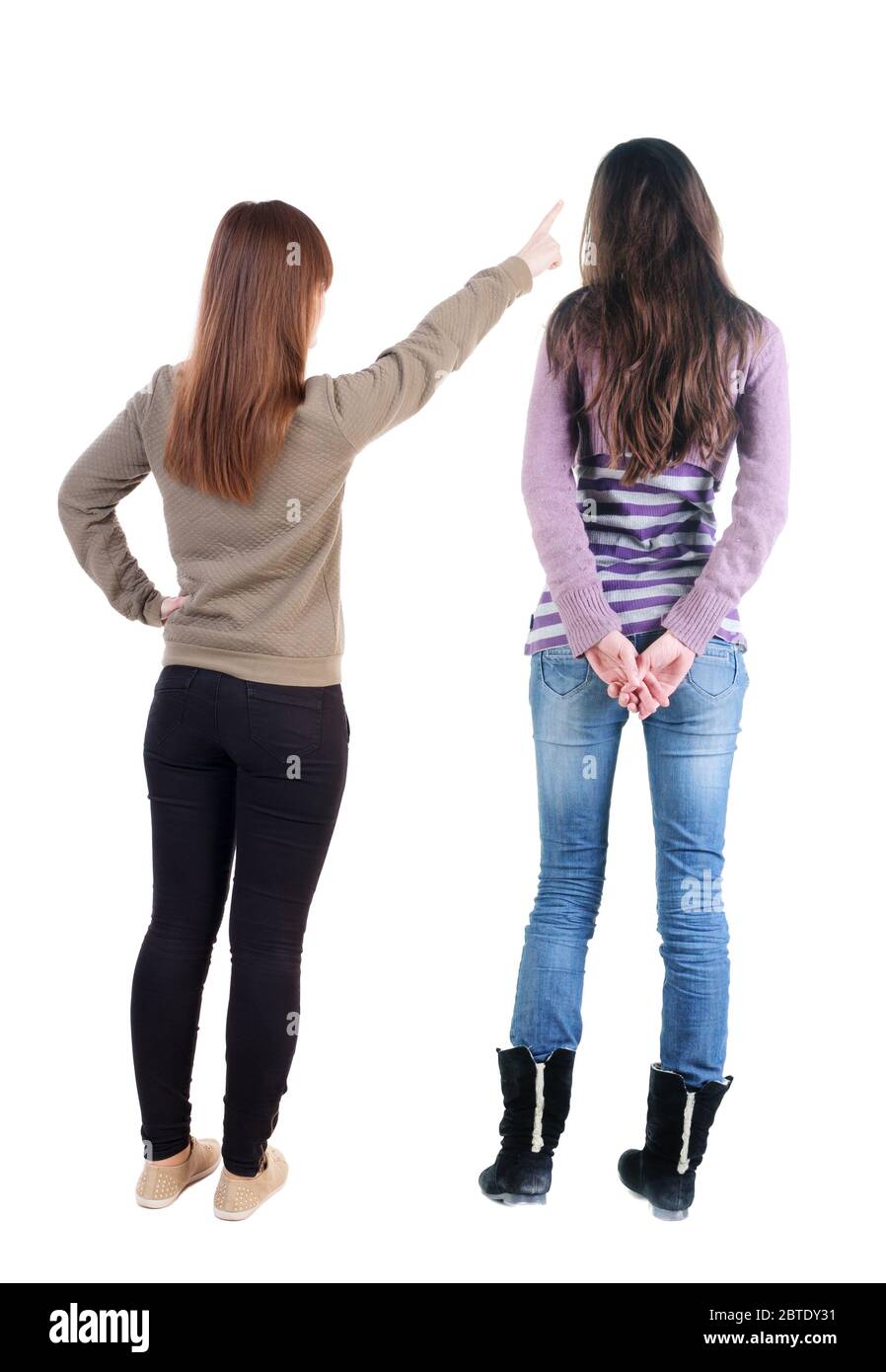 Back view of two young woman photographed on a mobile phone in sweater ...