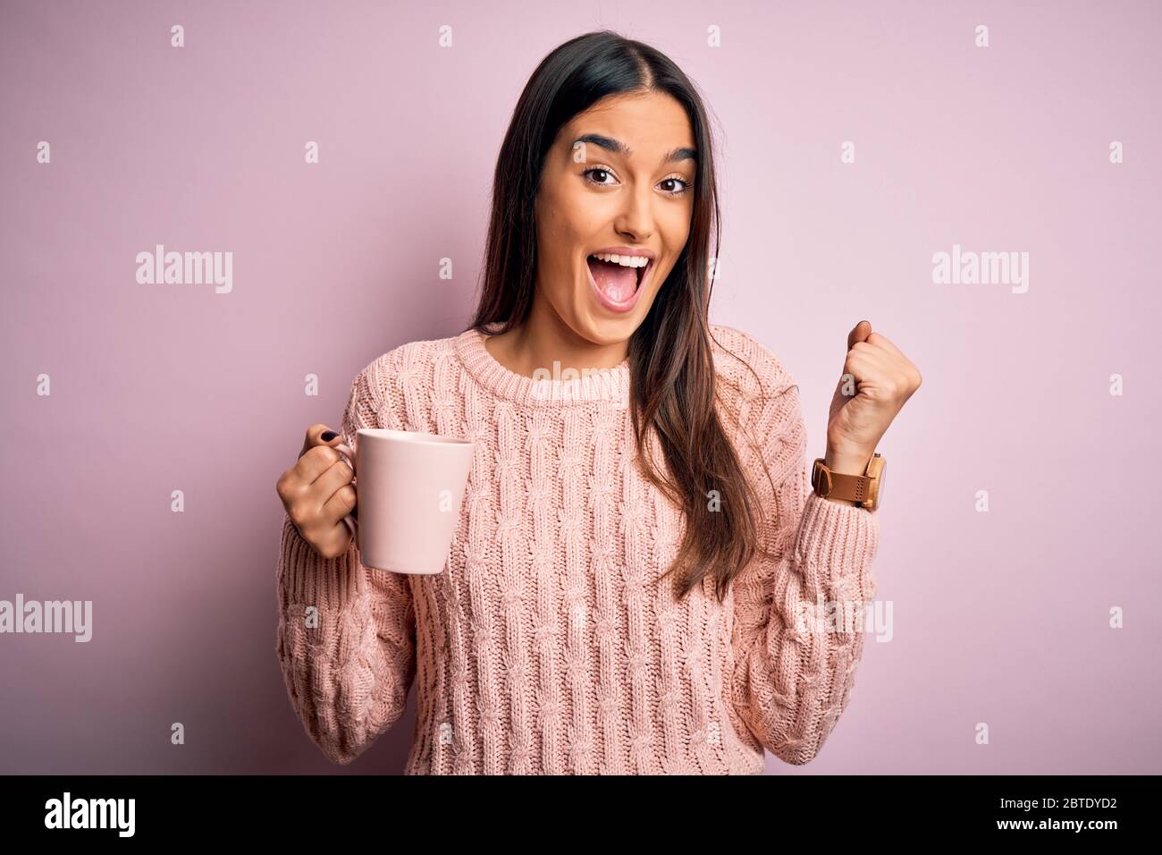 Young beautiful brunette woman drinking cup of coffee over isolated ...