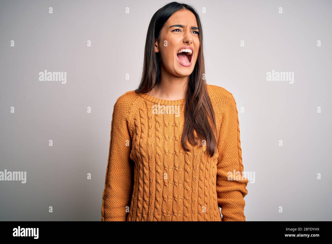 Young beautiful brunette woman wearing casual sweater over isolated ...