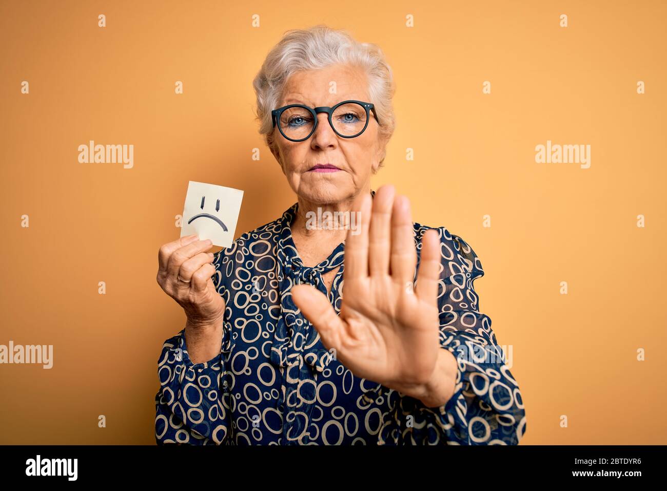 Senior beautiful grey-haired woman holding reminder paper with sad ...