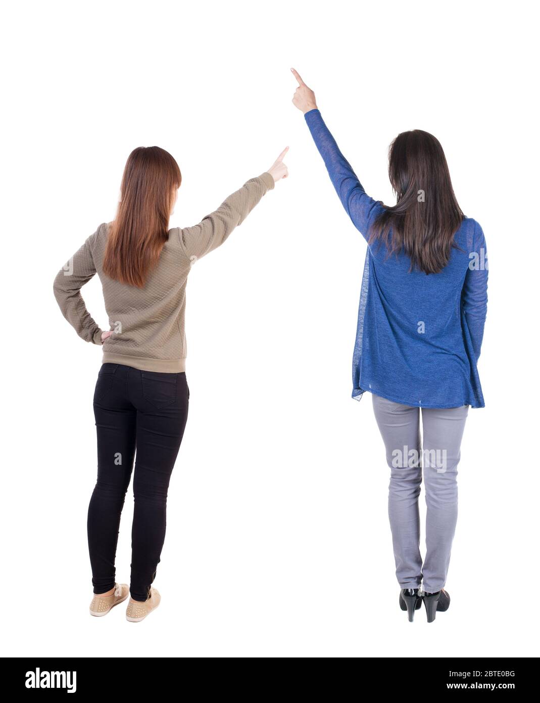Back view of two young woman photographed on a mobile phone in sweater ...