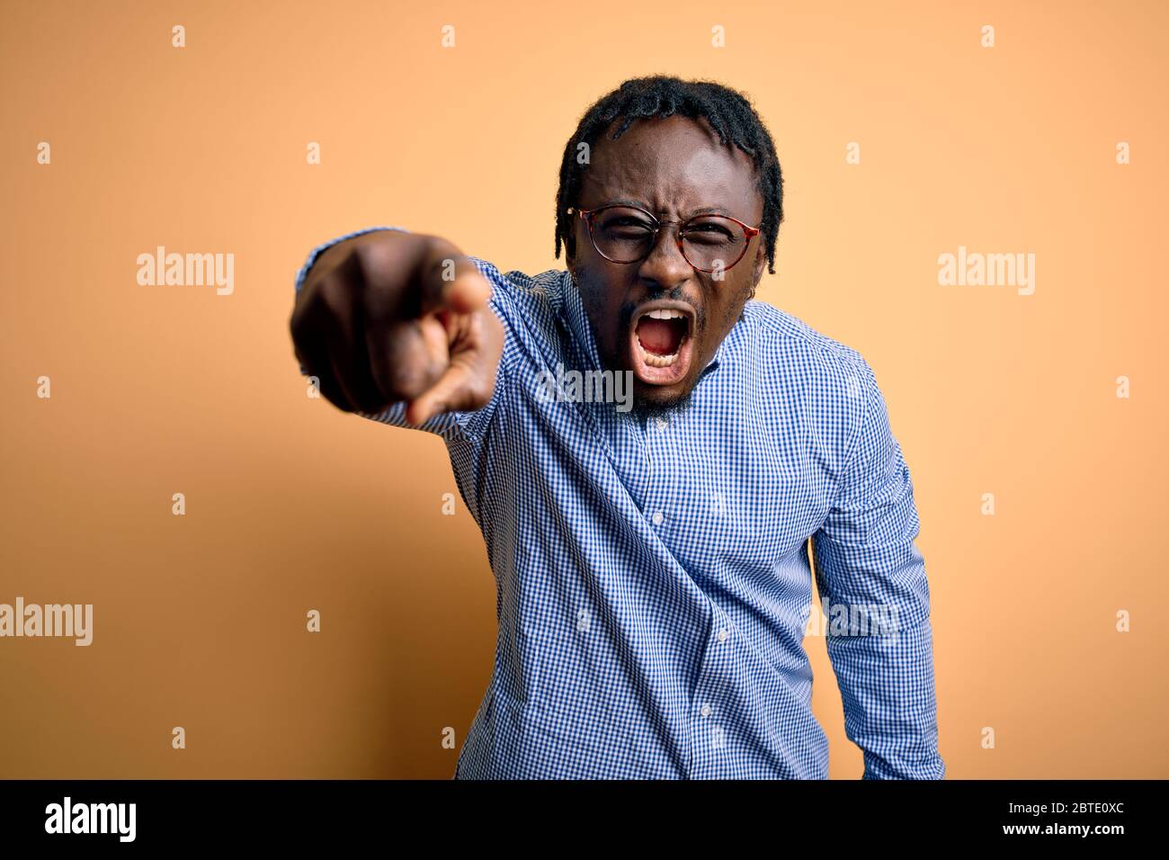 Young handsome african american man wearing shirt and glasses over ...