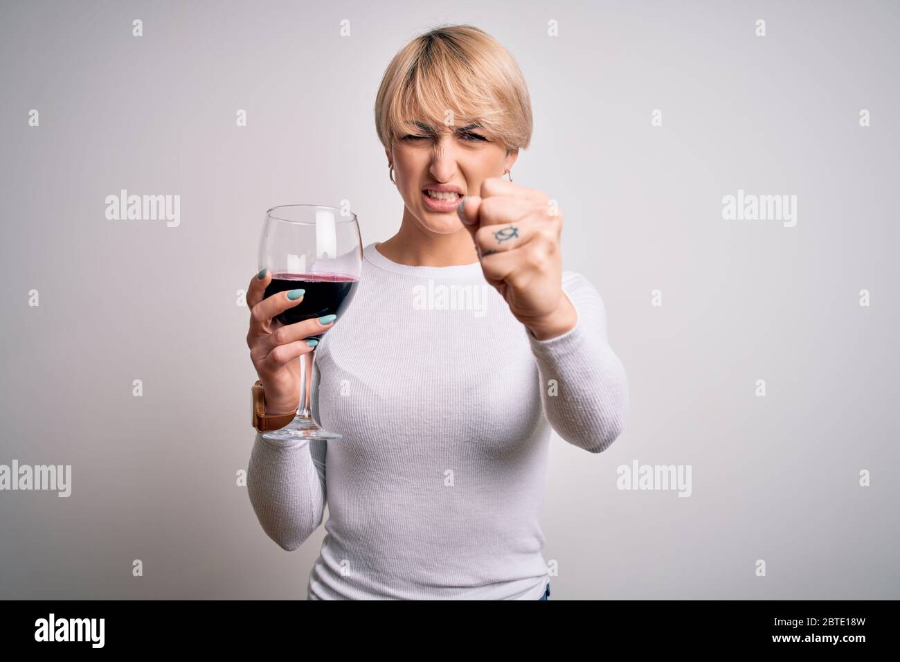 Angry woman holding a glass of wine hi-res stock photography and images ...