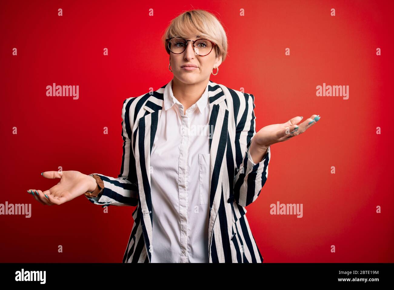 Blonde business woman with short hair wearing glasses and striped ...
