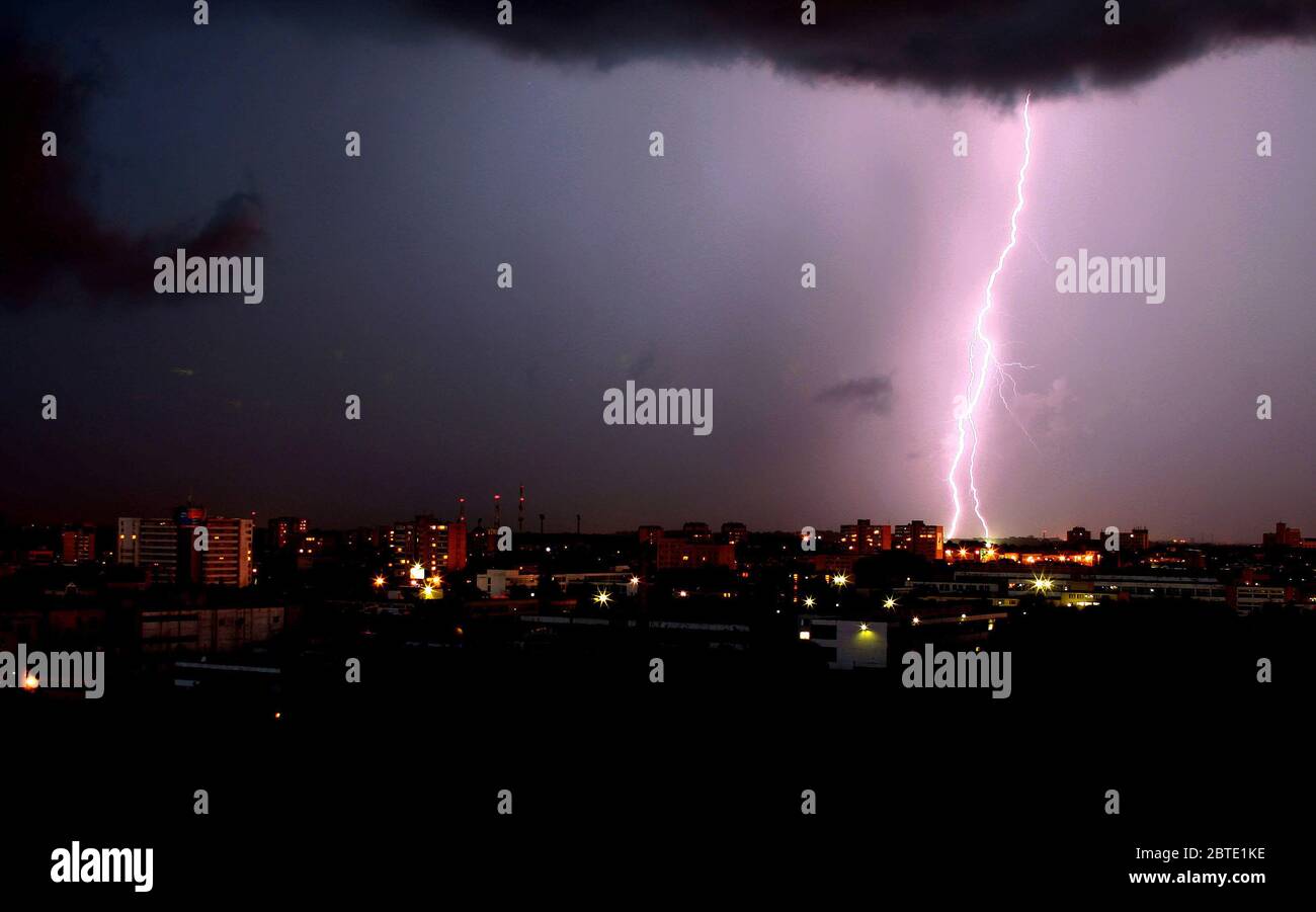 Lightning strikes down over the city at night. Long Exposure ...