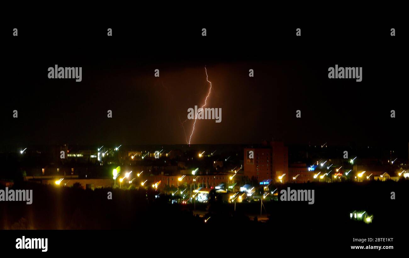 Lightning strikes down over the city at night. Long Exposure ...