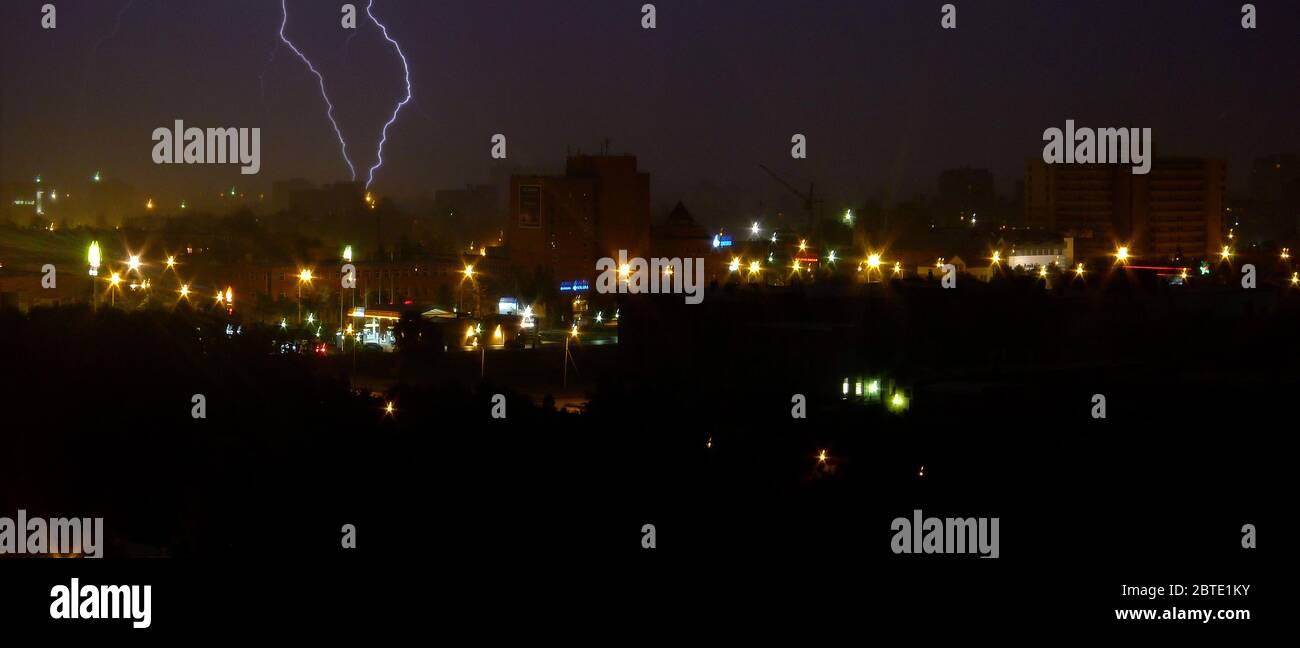 Lightning strikes down over the city at night. Long Exposure ...