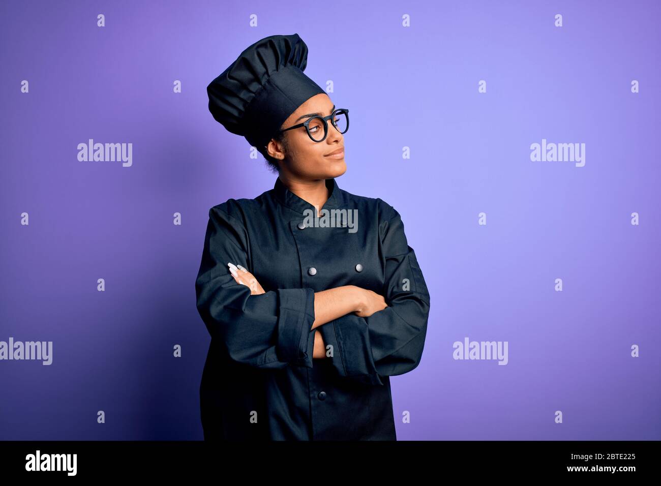 Young african american chef girl wearing cooker uniform and hat over ...