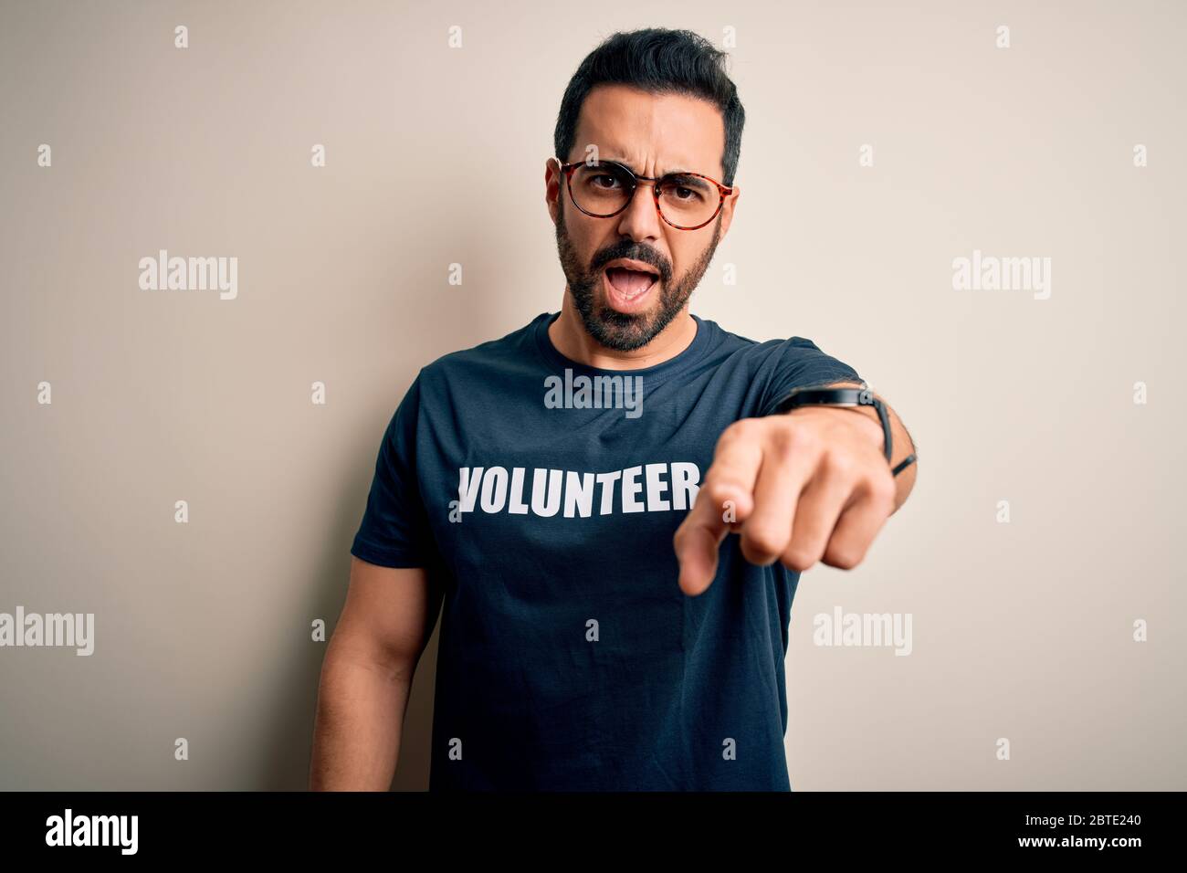 Handsome man with beard wearing t-shirt with volunteer message over ...