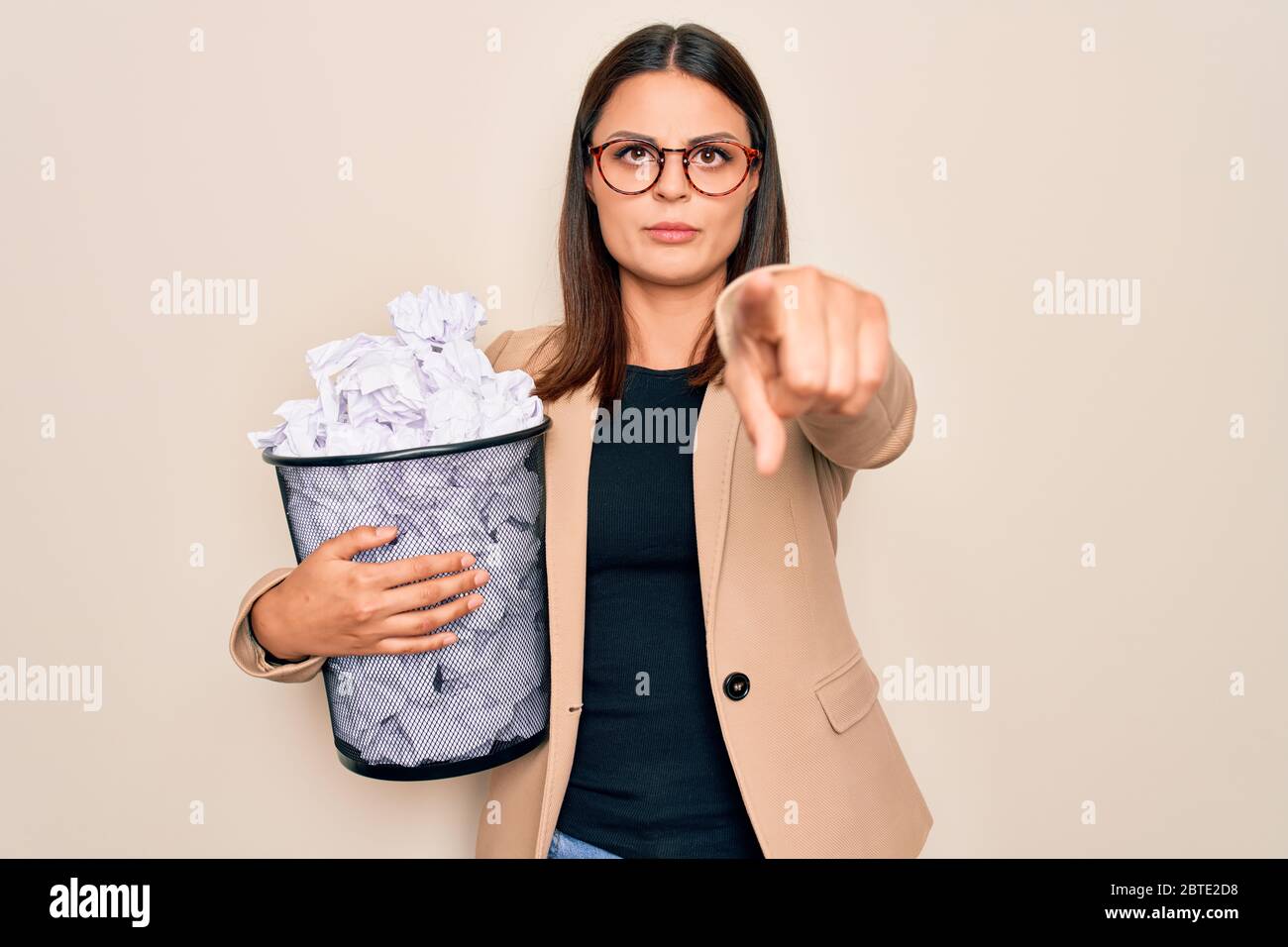 Young beautiful brunette business woman holding full paper bin of ...