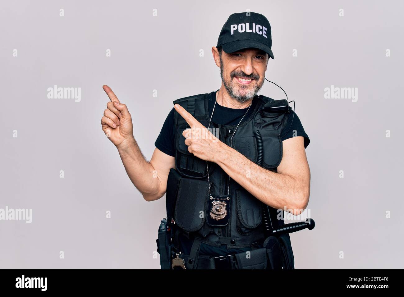 Middle age policeman wearing police uniform and bulletproof vest over ...