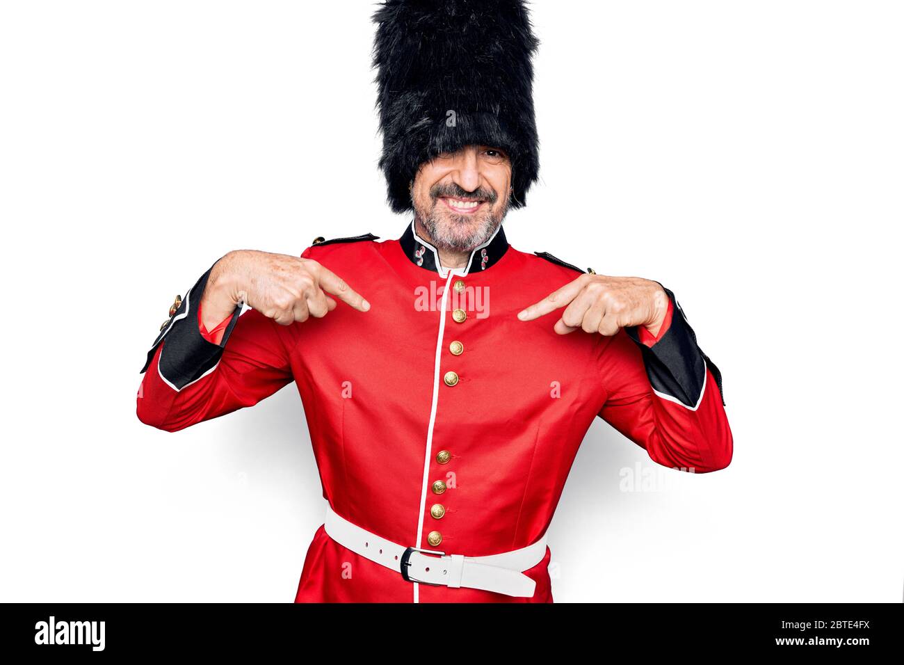 Middle age handsome wales guard man wearing traditional uniform over ...