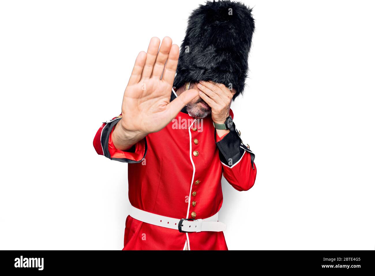 Middle age handsome wales guard man wearing traditional uniform over ...