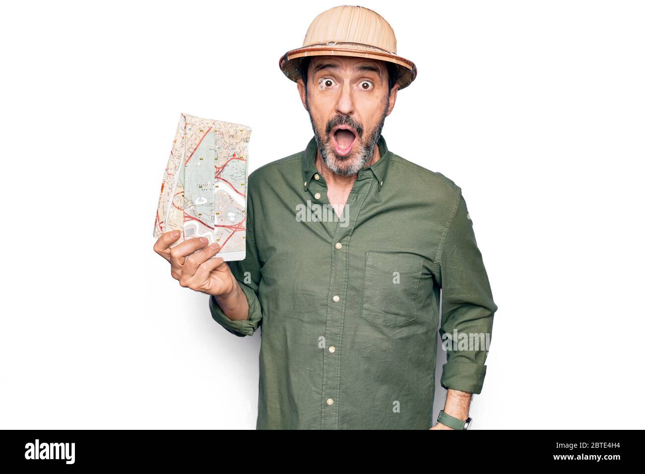 Middle age handsome tourist man on vacation wearing explorer hat ...