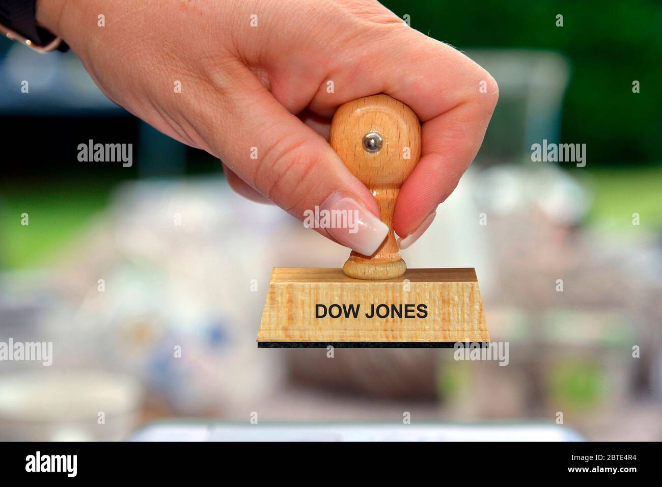 hand with stamp lettering DOW JONES Stock Photo - Alamy