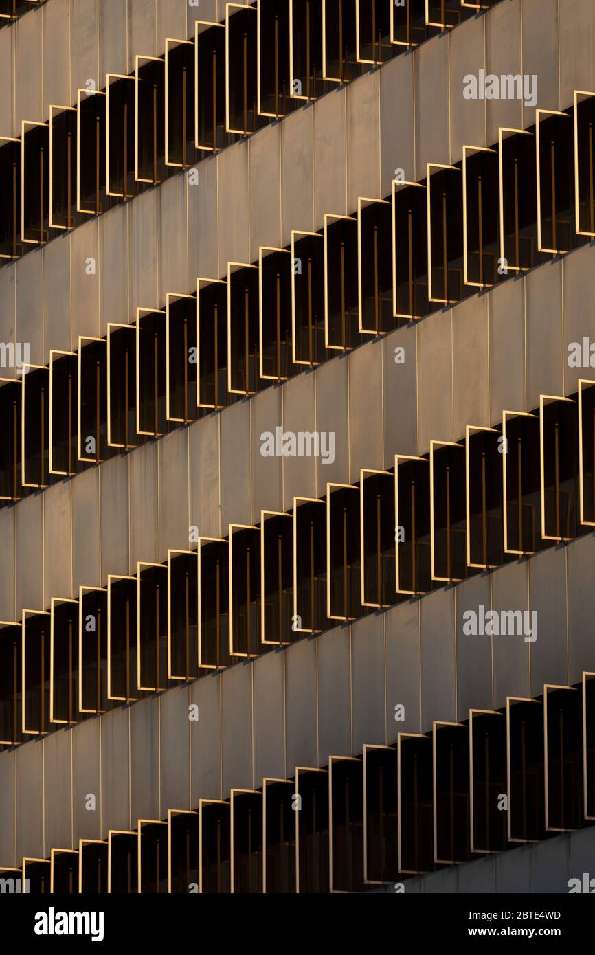 Facade of anonymous building, illuminated by the afternoon light, in ...