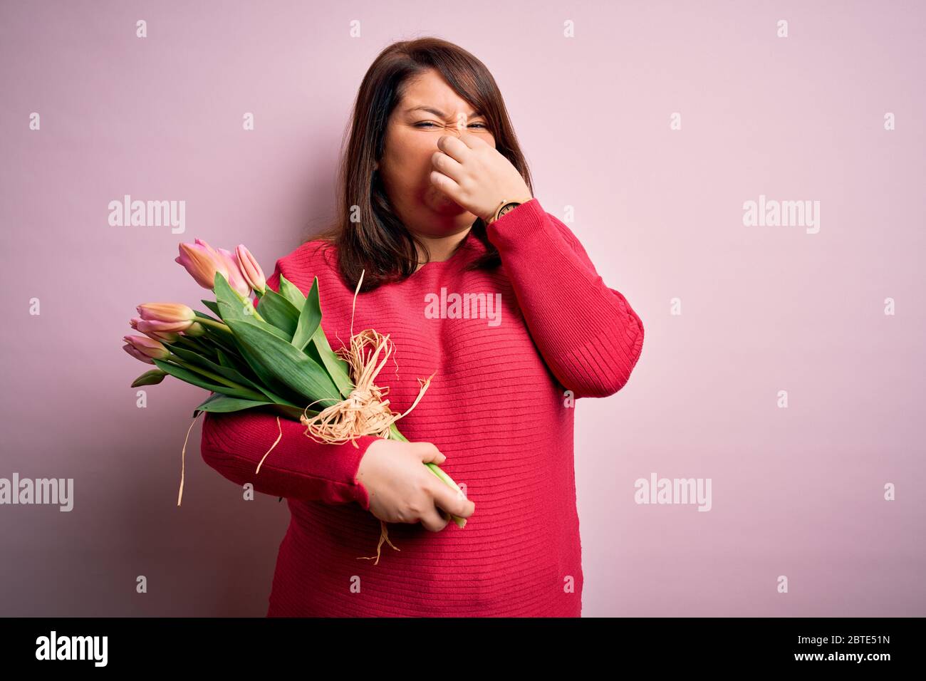 Beautiful plus size woman holding romantic bouquet of natural tulips ...