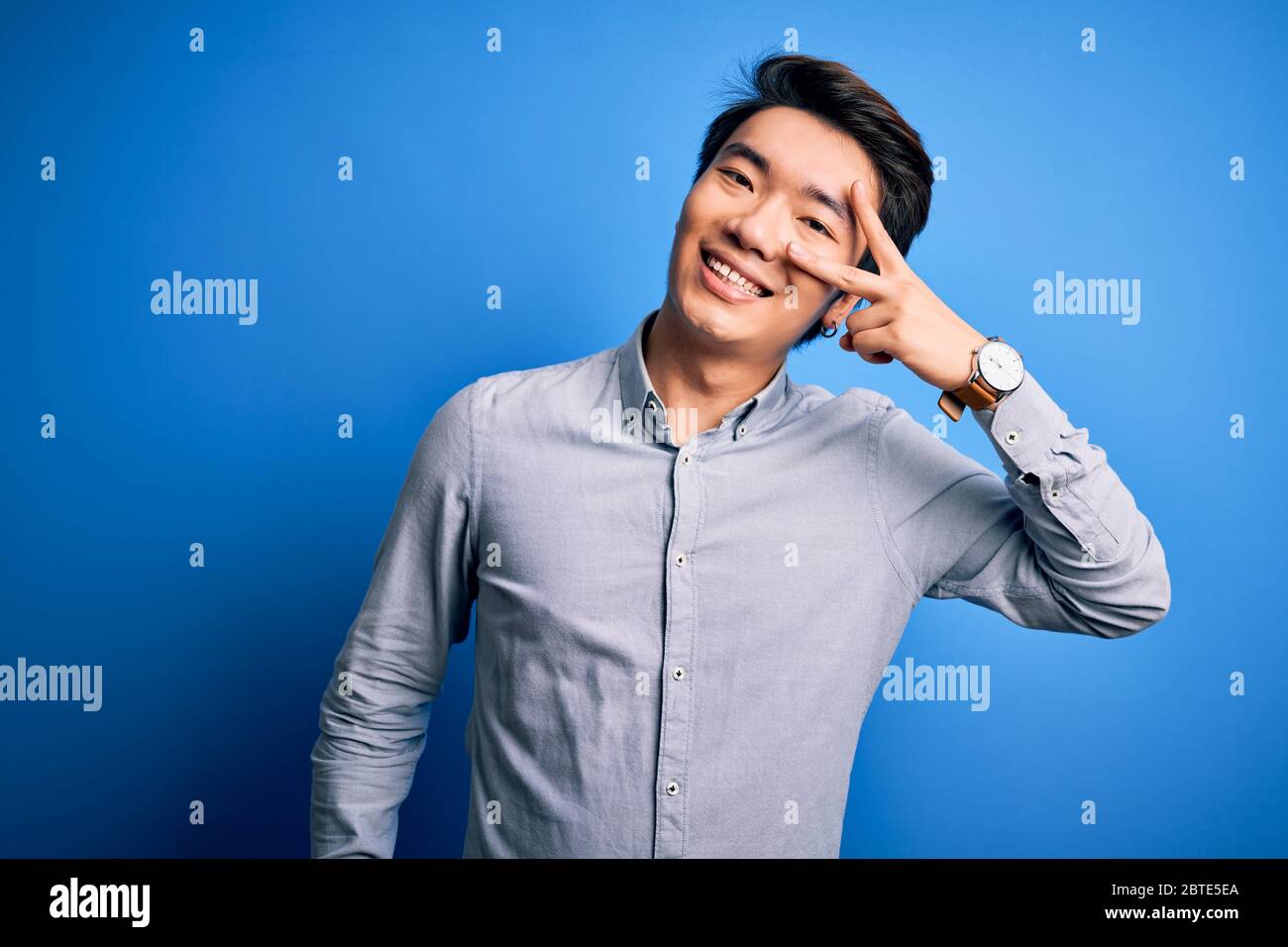 Young handsome chinese man wearing casual shirt standing over isolated ...