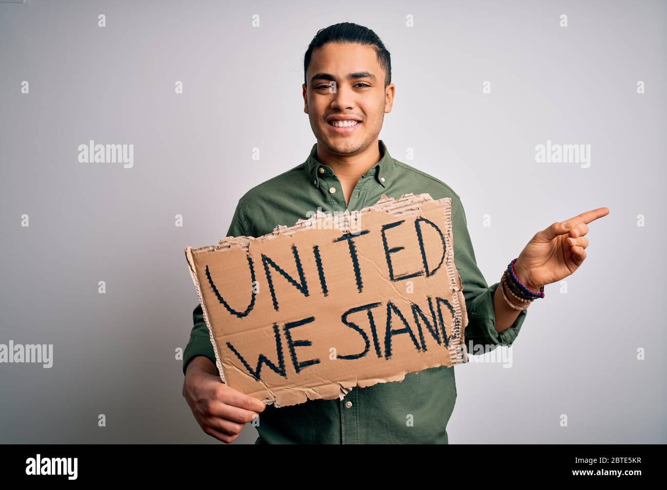 Young brazilian activist man asking for union holding banner with ...