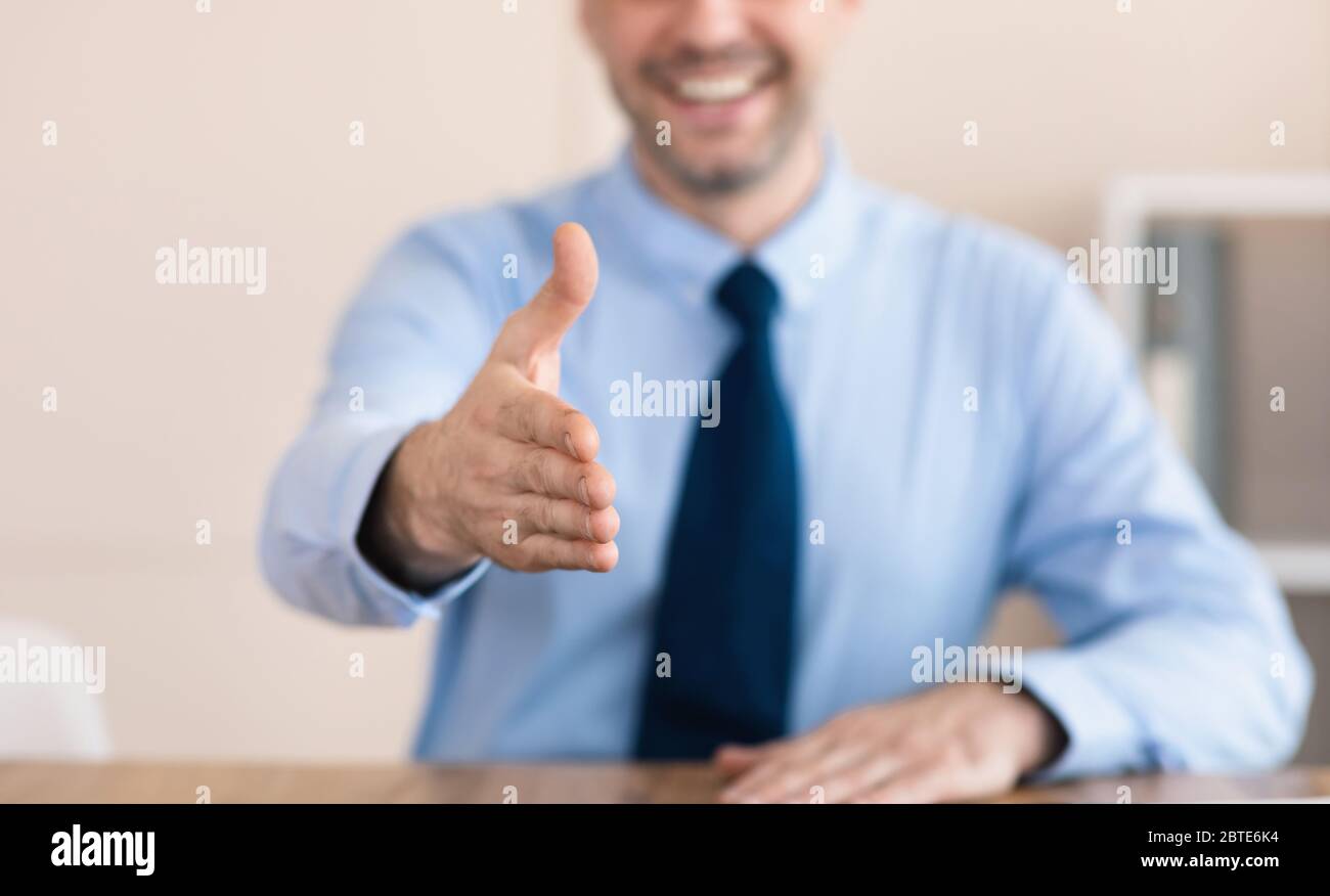 Businessman offering handshake office desk hi-res stock photography and ...