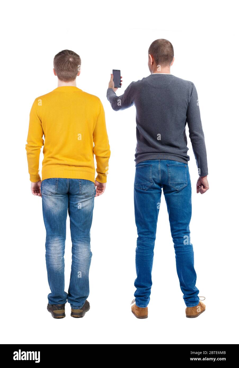 Back view of two man in sweater with mobile phone. Rear view people ...