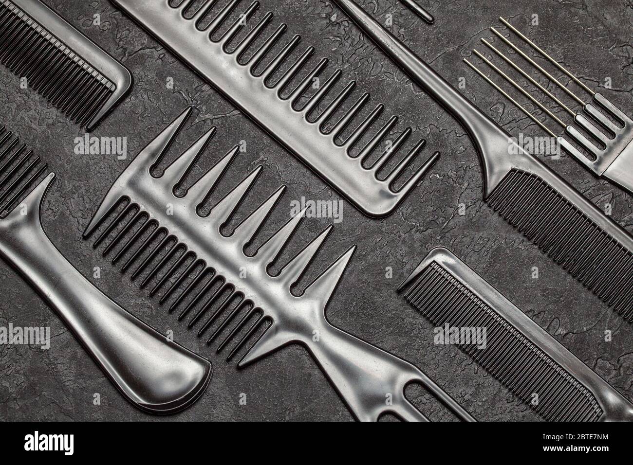 Black combs and combs on a black background Stock Photo - Alamy