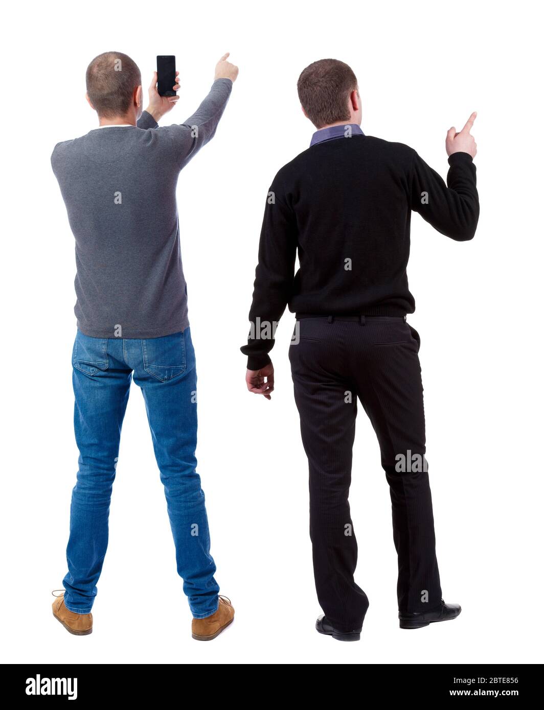 Back view of two man in sweater with mobile phone. Rear view people ...