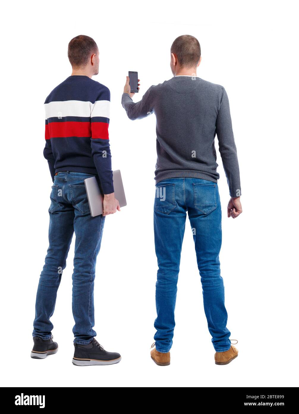 Back view of two man in sweater with mobile phone. Rear view people ...
