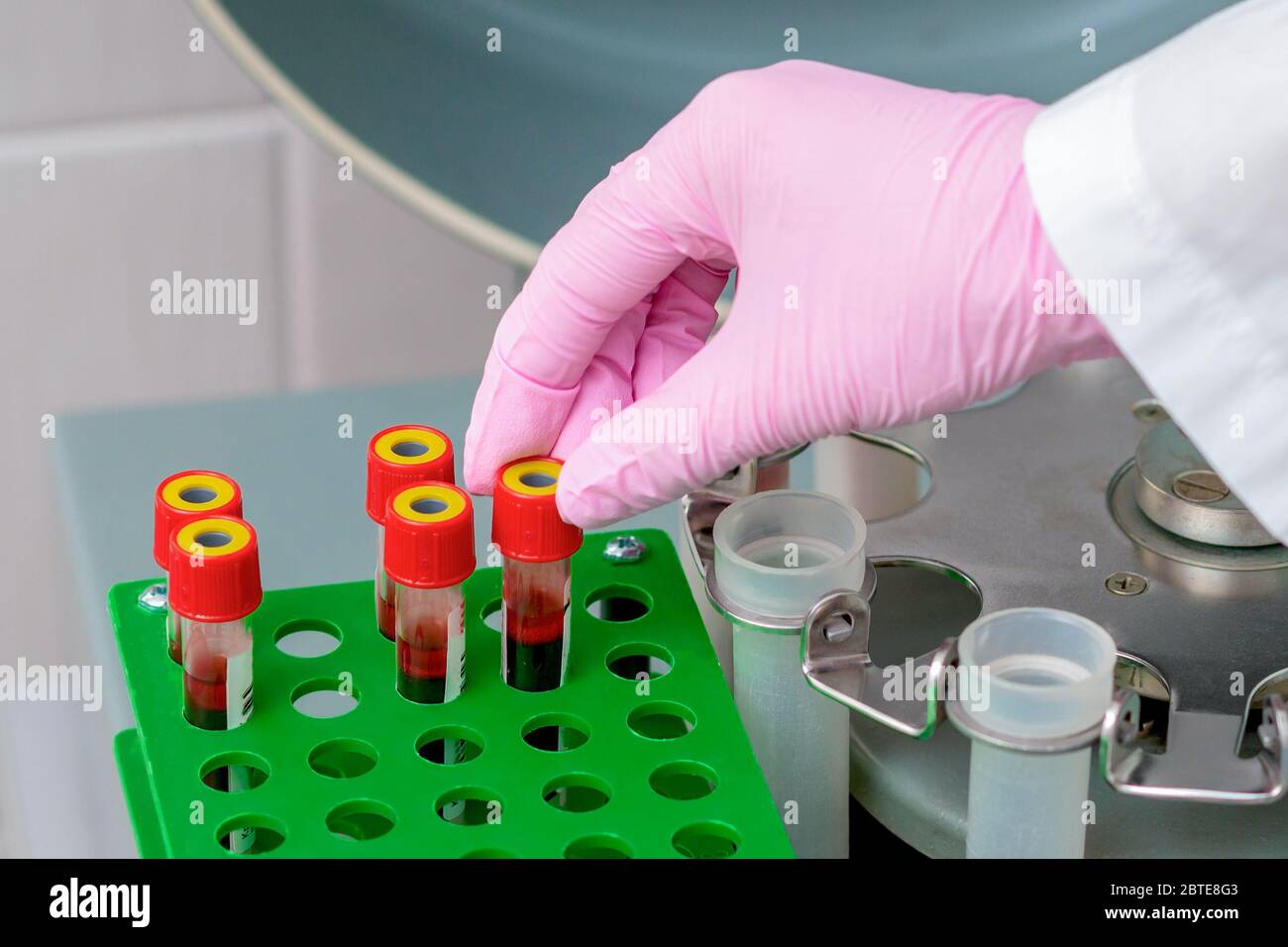 Hand of doctor taking test tube with blood from tray in lab Stock Photo ...