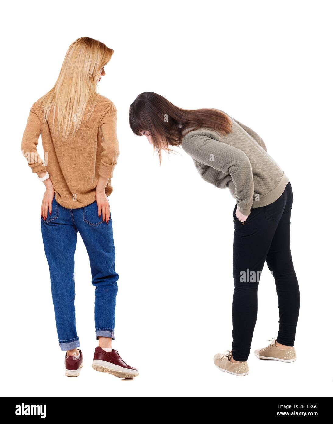 Back view of two woman in sweater. Rear view people collection ...