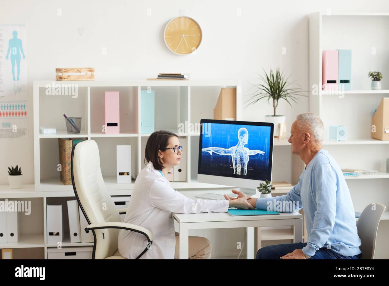 Wide angle side view portrait of female doctor checking heart rate of ...