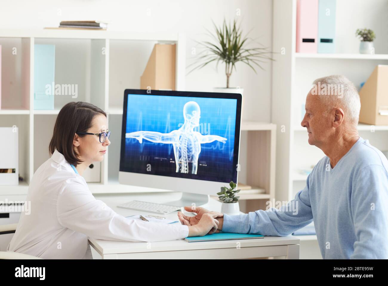 Side view portrait of female doctor checking heart rate of senior ...