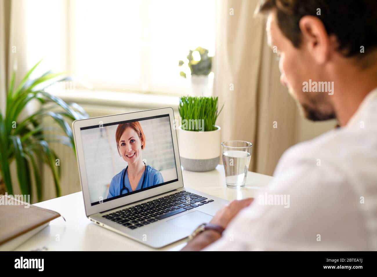 Man having video call with doctor on laptop at home, online ...